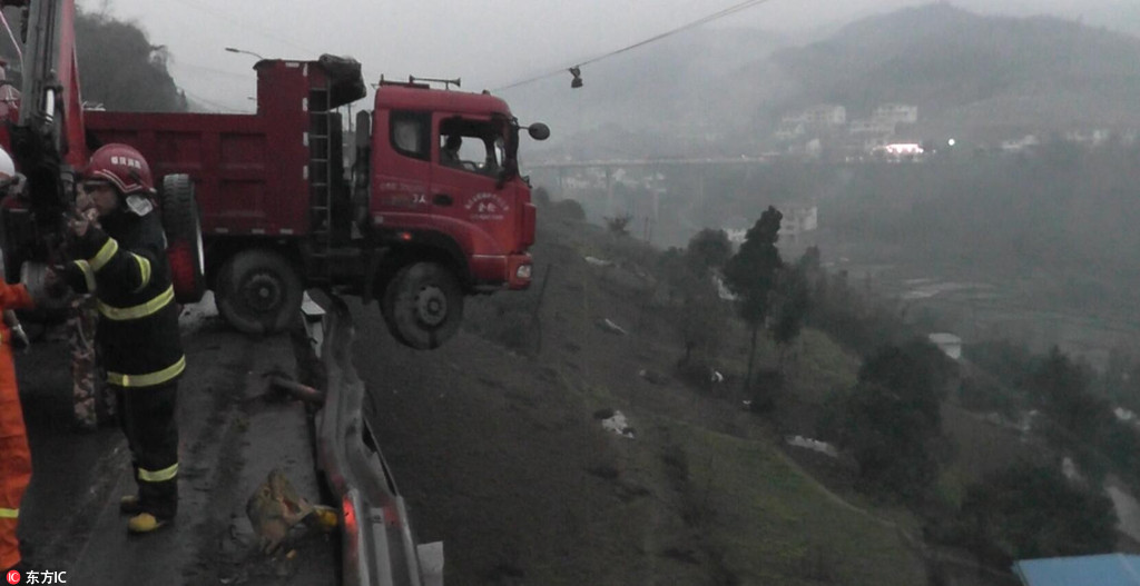 Truck sideslips and hung dangling over cliff, with a family of four ...