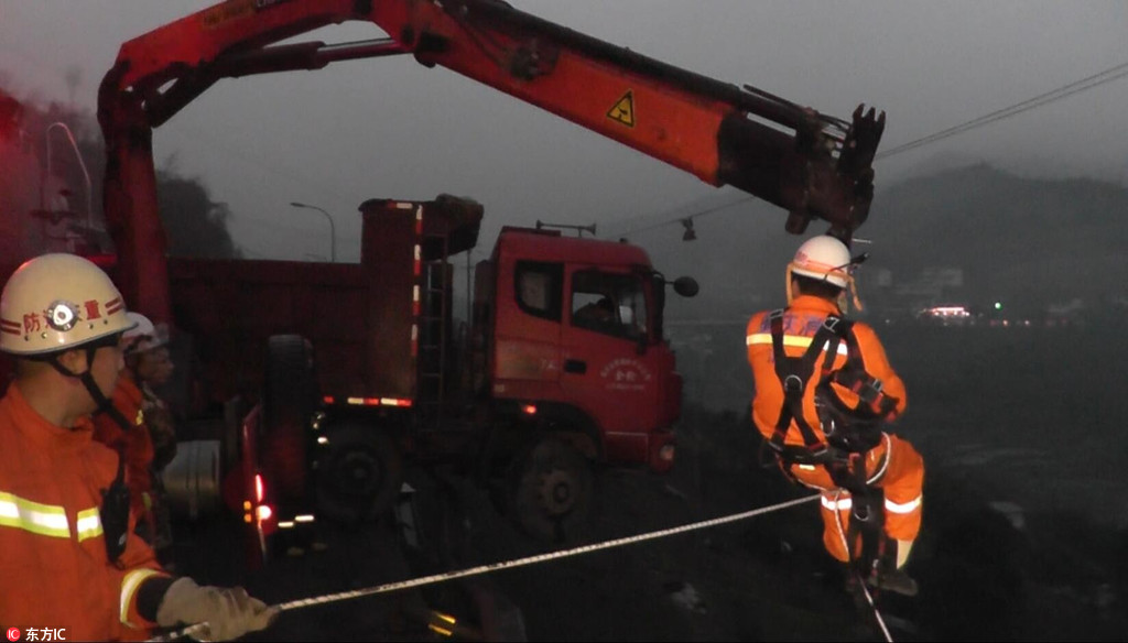 Truck sideslips and hung dangling over cliff, with a family of four ...